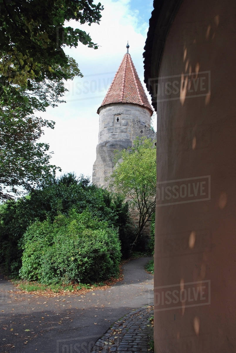 A building with a round tower and peaked roof;Germany - Royalty-free ...