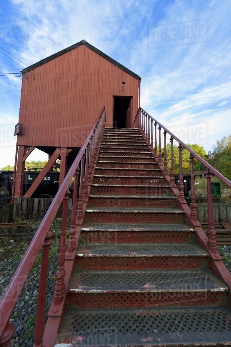 Stairs Leading Up To An Elevated Building Along The Train Tracks ...