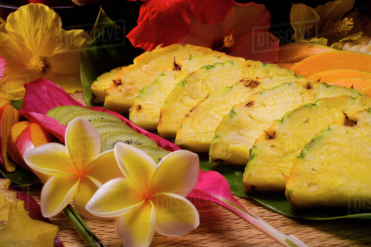Studio Shot Of A Variety Of Tropical Fruit Cut Into Slices, With ...