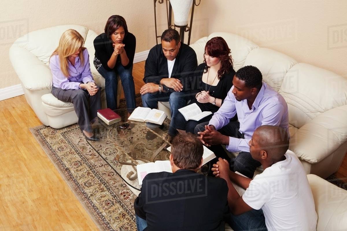 A Group Of Adults Praying With Their Bibles Open - Royalty-free Stock ...