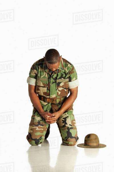 A Military Man Kneeling With His Head Bowed In Prayer - Royalty-free ...