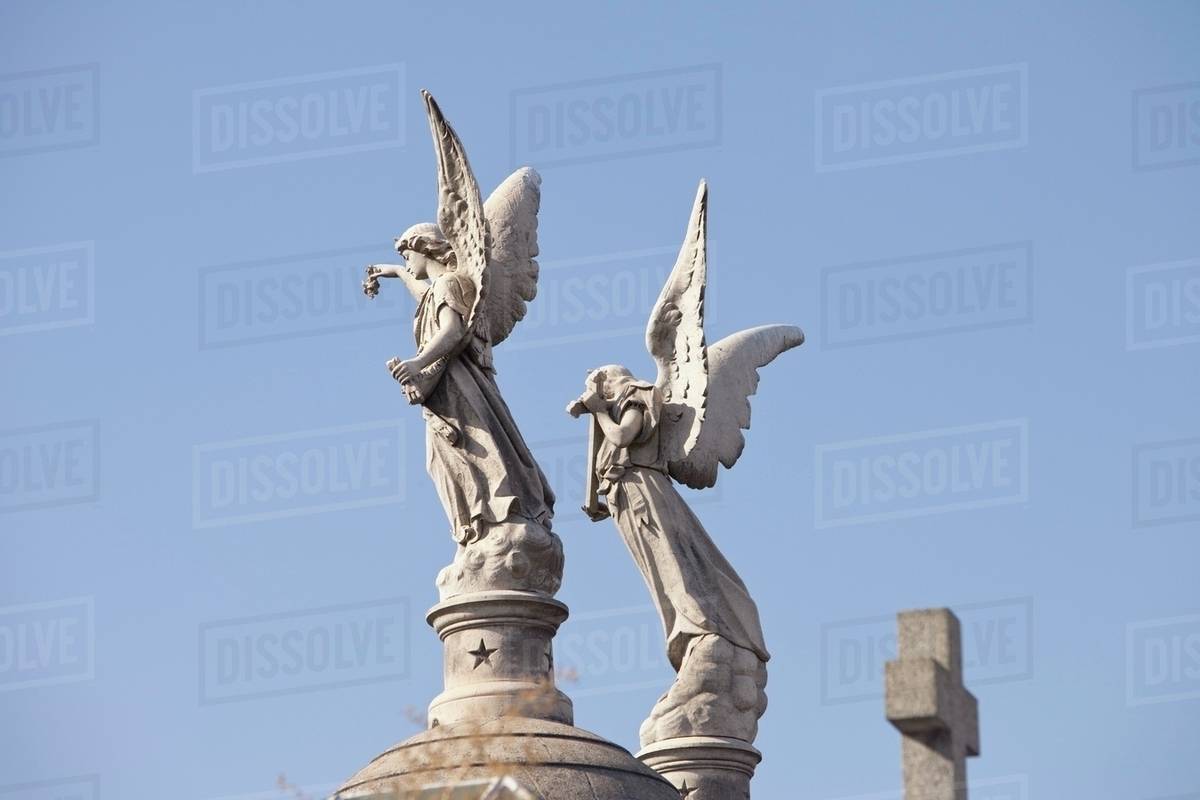 Buenos Aires, Argentina; Angel Statues And A Cross Made Of Stone In ...
