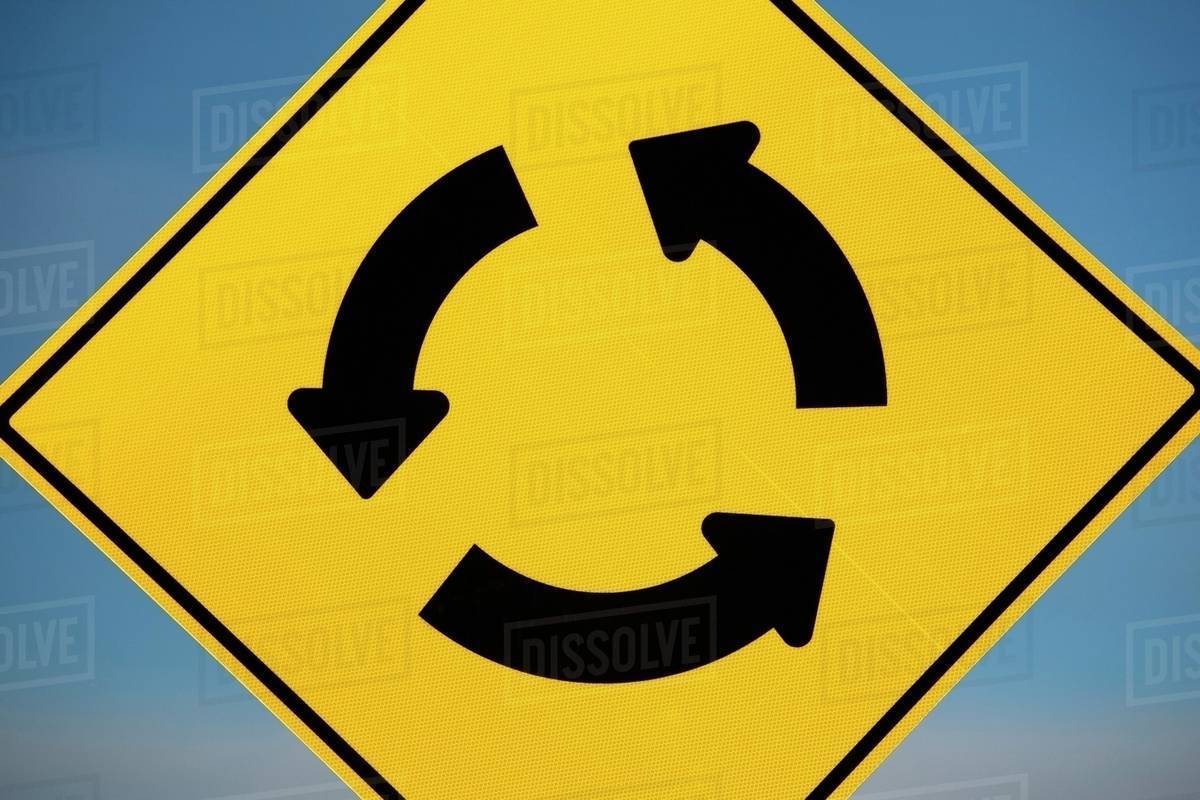 A Yellow Sign Showing Three Arrows Going In A Circle; Calgary, Alberta, Canada - Royalty-free ...