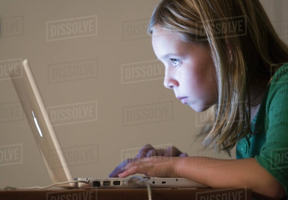 Young Girl Using Computer - Stock Photo - Dissolve