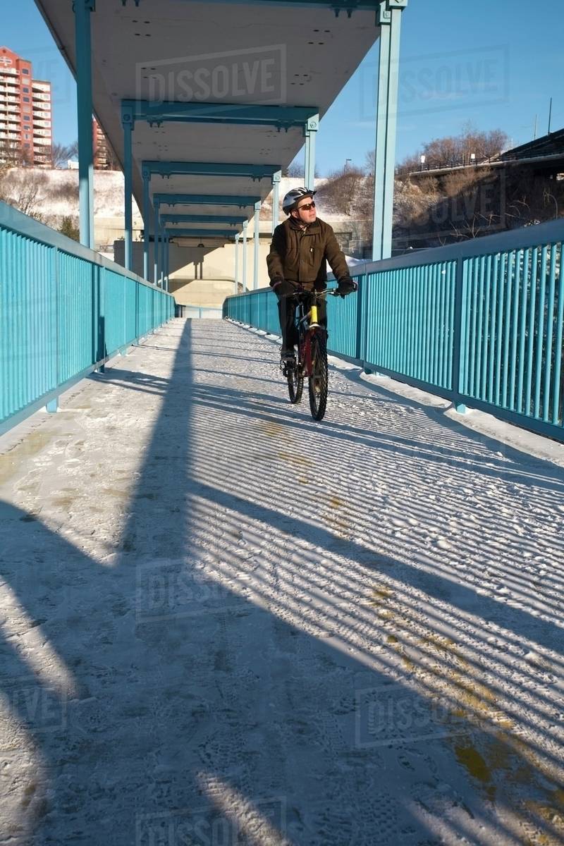 Man Riding A Bicycle In The Winter - Stock Photo - Dissolve