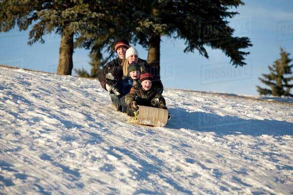 Family Tobogganing - Stock Photo - Dissolve