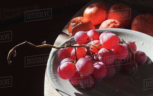 Fruit; Red Grapes On Plate With Mandarins In Background - Stock Photo ...