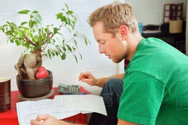 Man Working With Calculator - Royalty-free Stock Photo | Dissolve