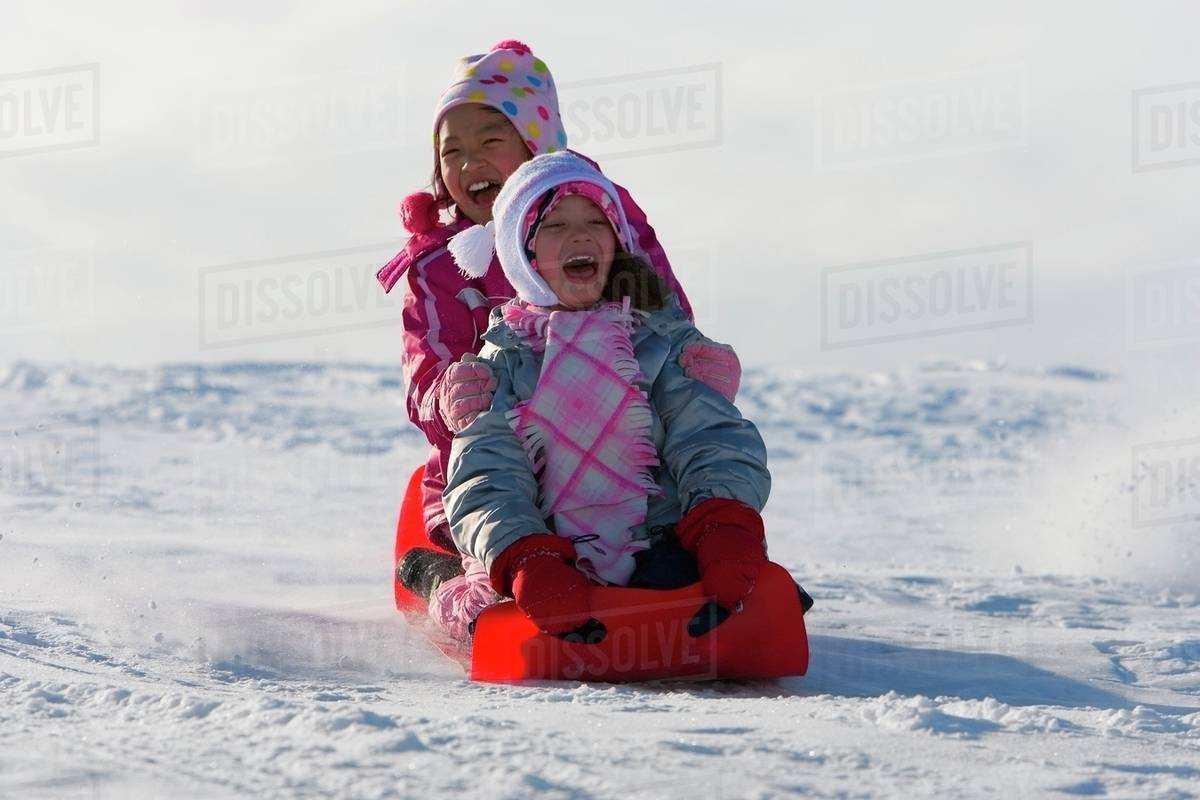 Children Tobogganing - Royalty-free Stock Photo | Dissolve