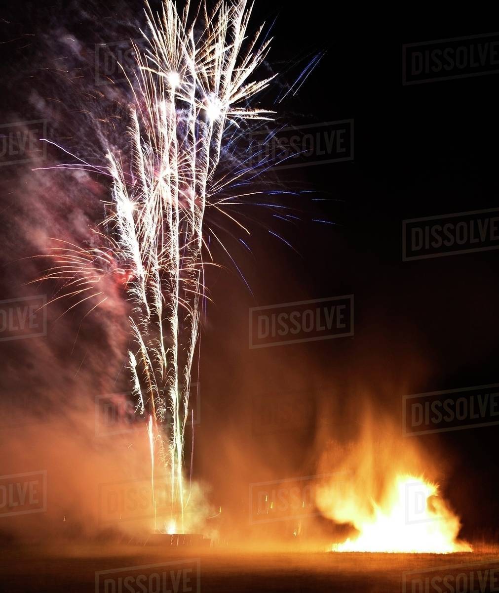 Fireworks Next To A Bonfire - Stock Photo - Dissolve