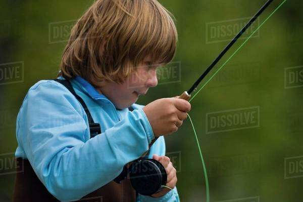 Boy Fly Fishing - Stock Photo - Dissolve