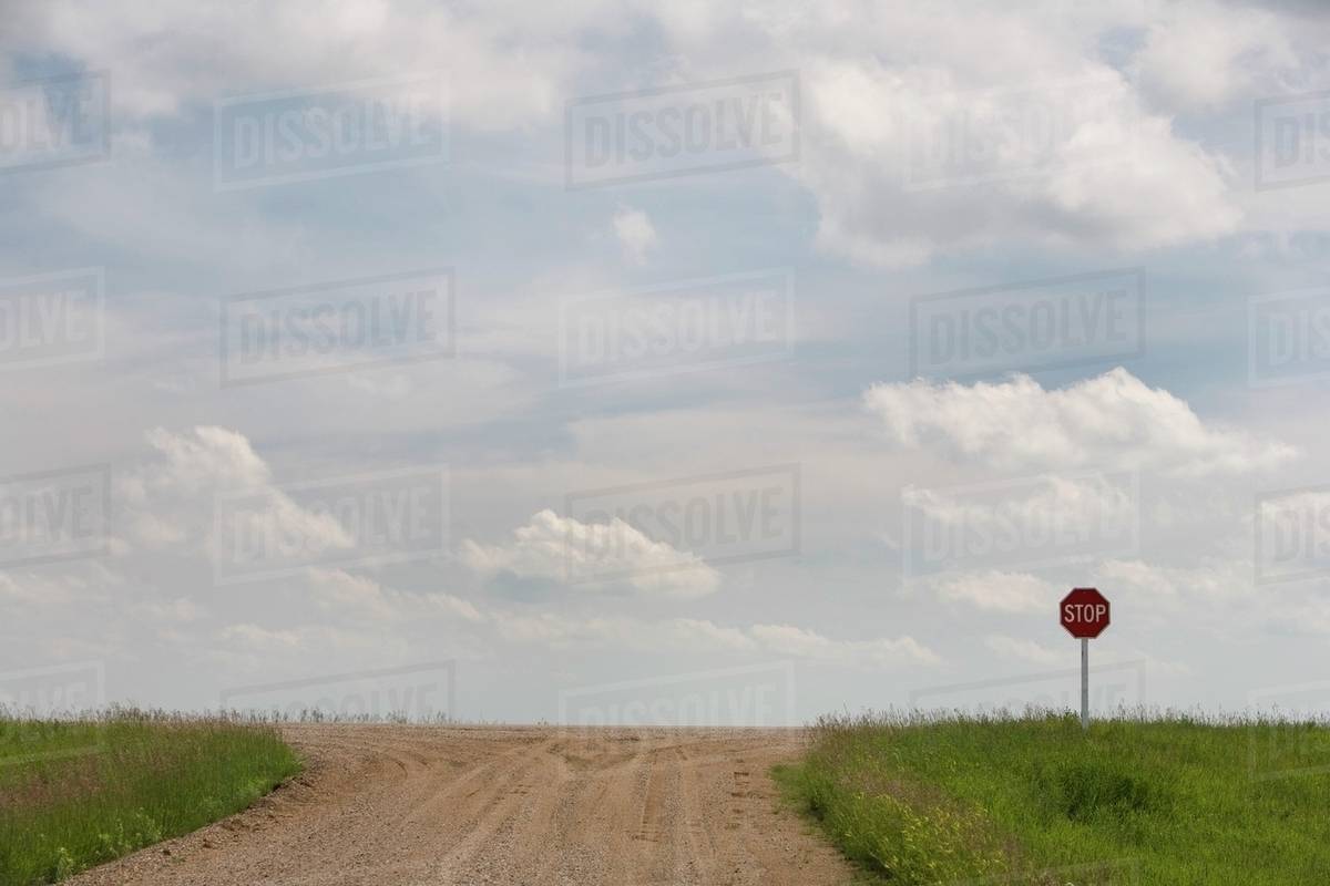 A Dirt Road And Stop Sign - Royalty-free Stock Photo | Dissolve