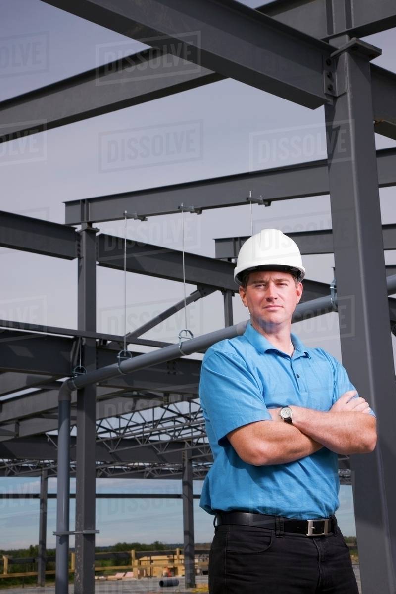 Engineer Leaning Against Metal Beam - Stock Photo - Dissolve