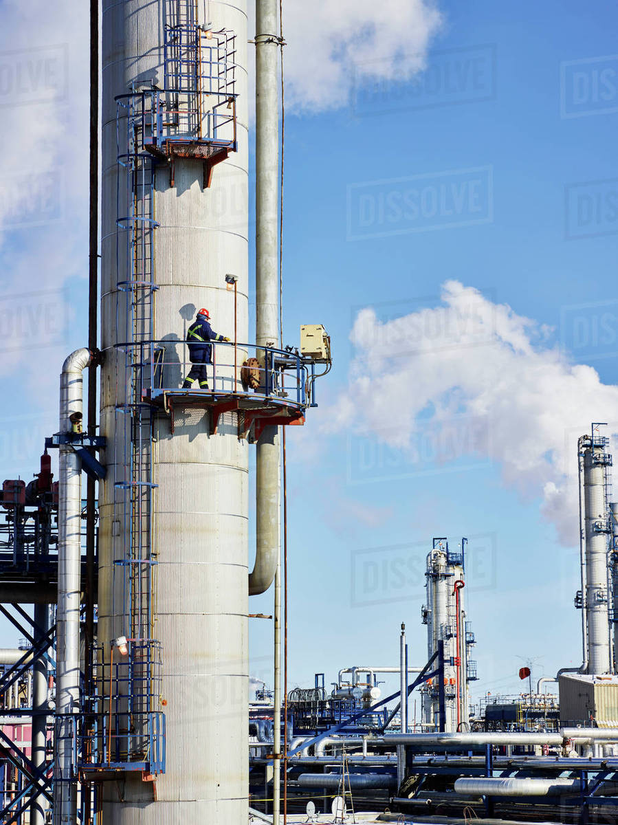 A Tradesman Working On A Tower Platform At A Refinery; Edmonton ...