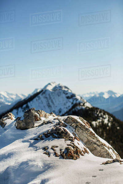 Footprints in the snow of Sulphur Mountain with a view of the Rocky ...