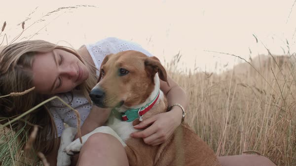 Brother and sister sitting on couch having fun playing and petting ...