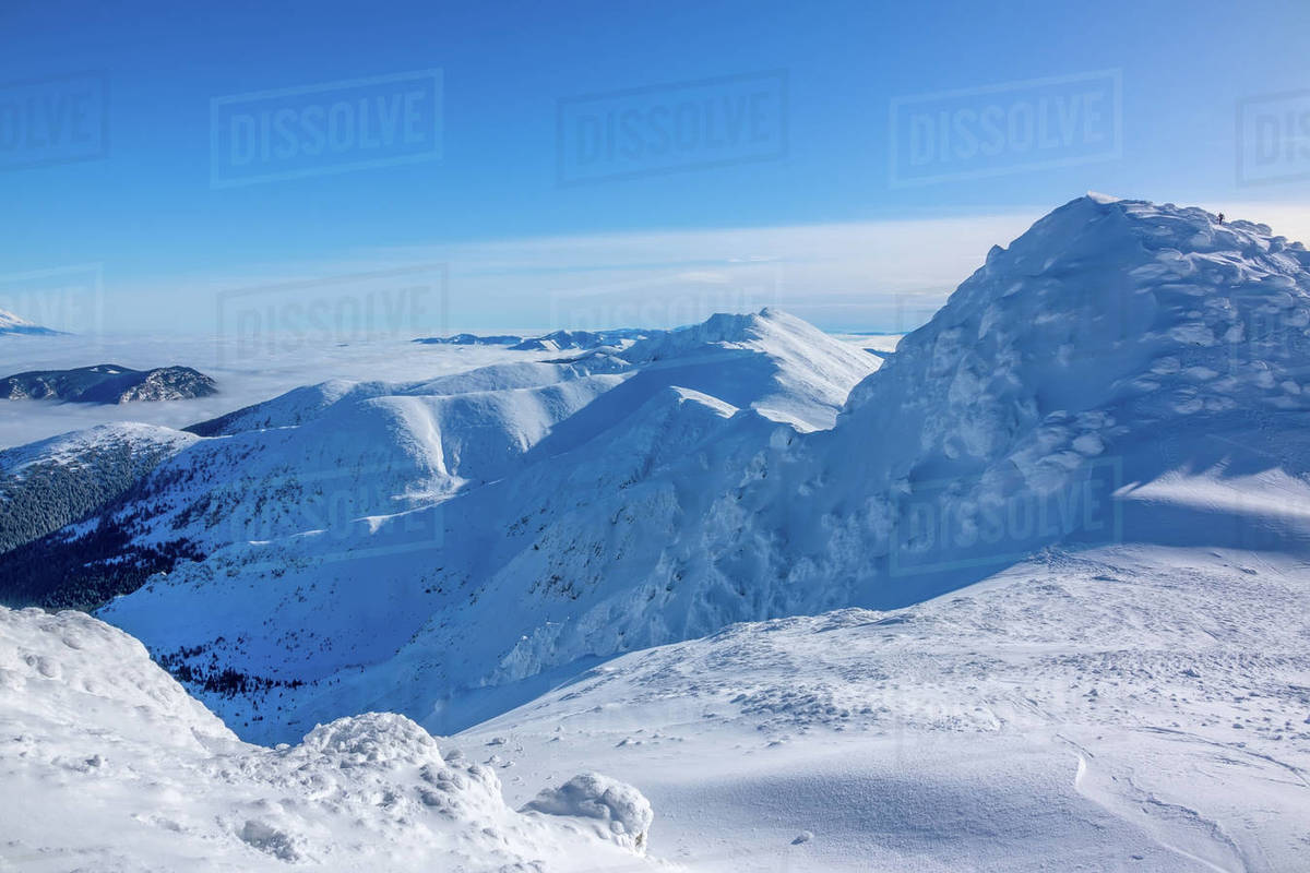 A lot of snow on the peaks and slopes of the winter mountains. Sunny ...