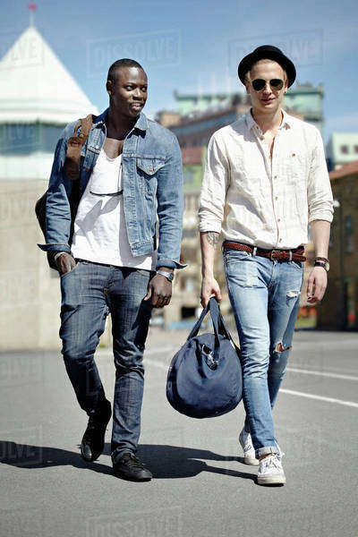 Two guys walking on street - Stock Photo - Dissolve