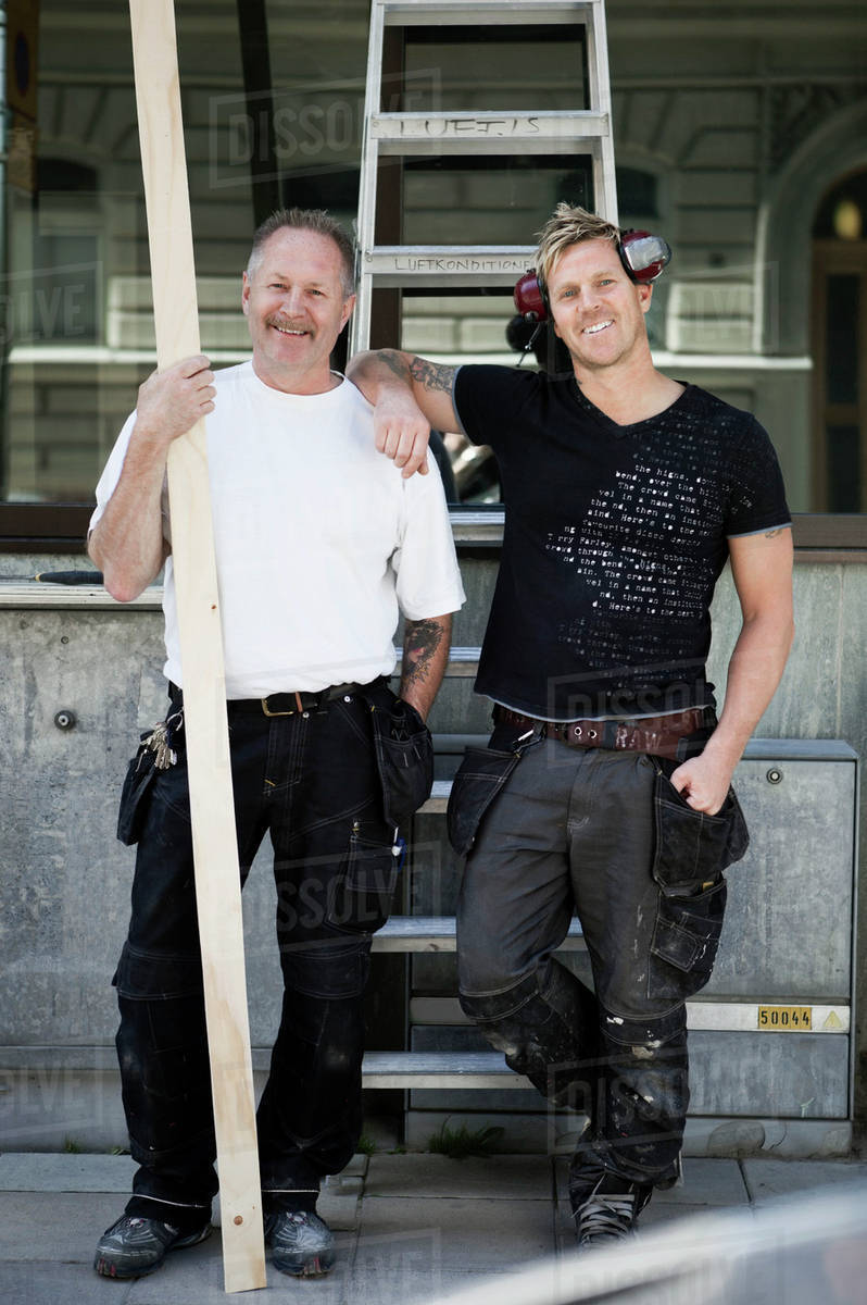 Full length of happy carpenters - Royalty-free Stock Photo | Dissolve