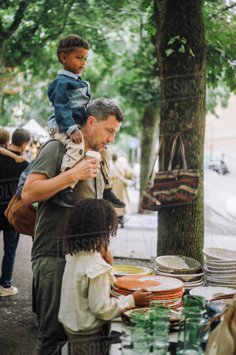 Father with son and daughter doing shopping at flea market - Royalty ...