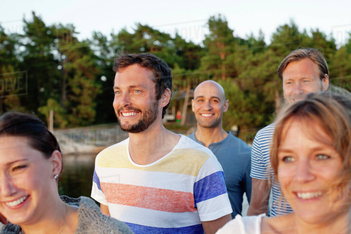 Friends smiling together outdoors - Royalty-free Stock Photo | Dissolve