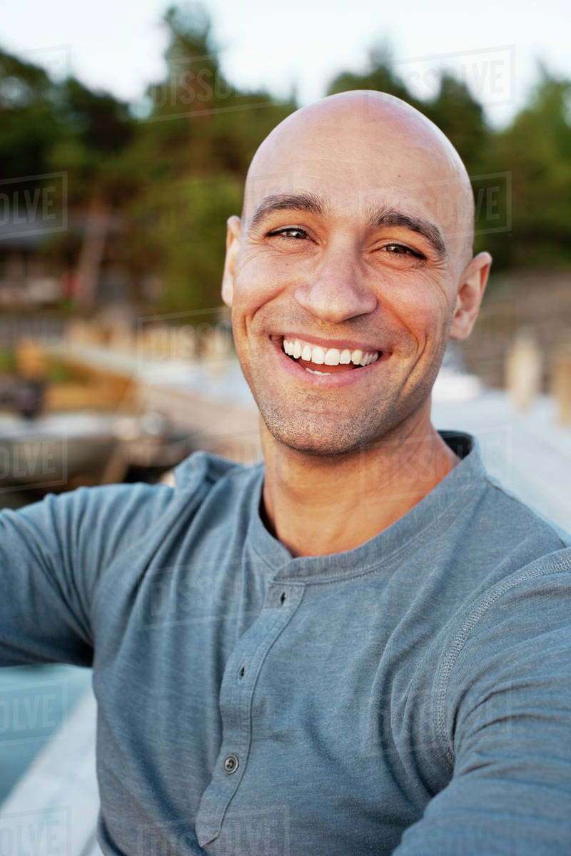 Portrait of cheerful man smiling while looking at you - Royalty-free ...