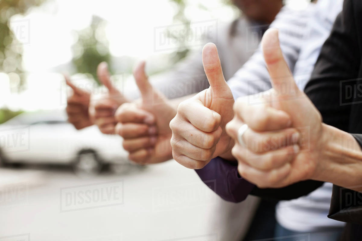 Human hands showing thumbs up sign - Stock Photo - Dissolve