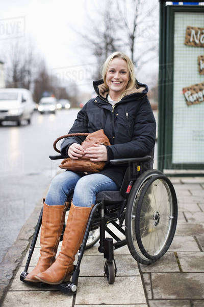 Portrait of happy disabled woman in wheelchair smiling outdoors - Stock ...