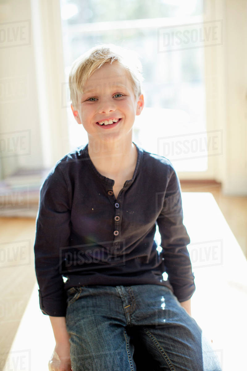 Portrait of happy boy sitting in house - Royalty-free Stock Photo ...