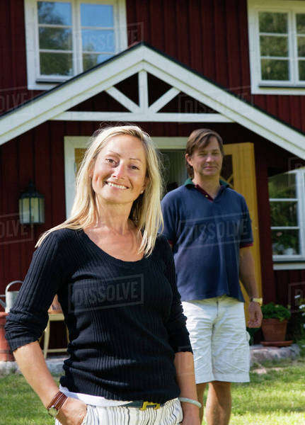 Woman and man in front of house - Royalty-free Stock Photo | Dissolve