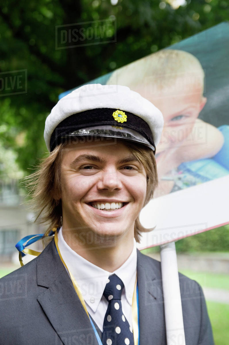 Male student with sign - Stock Photo - Dissolve