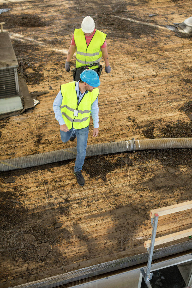 High angle view of construction workers walking at site - Royalty-free ...