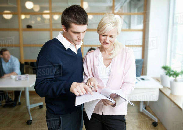 Colleagues helping each other - Royalty-free Stock Photo | Dissolve