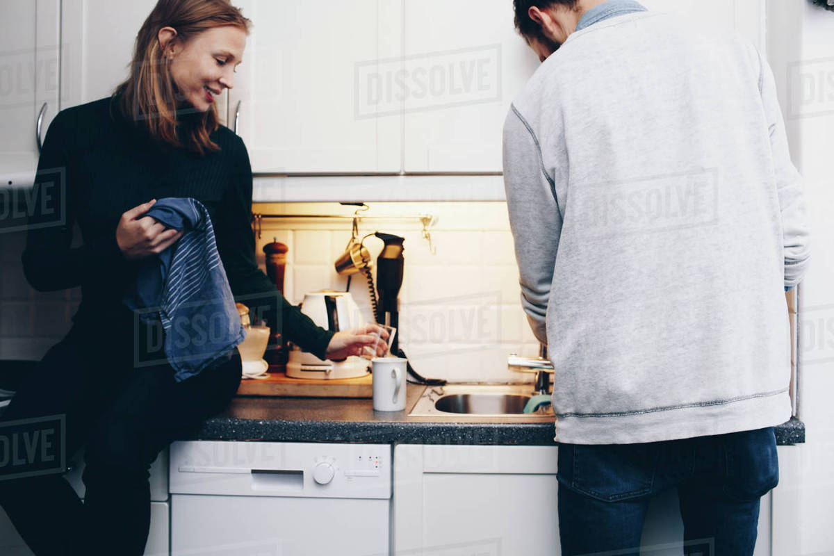 Couple washing dishes in kitchen at home - Royalty-free Stock Photo ...