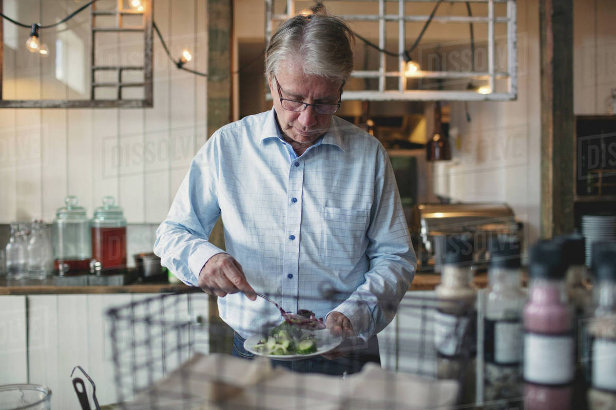 Senior man taking food in plate at buffet counter - Royalty-free Stock ...