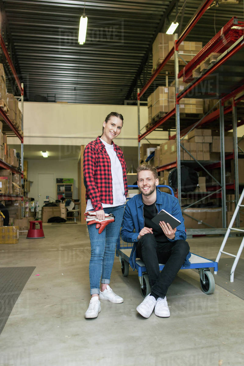 Portrait of smiling colleagues in distribution warehouse - Stock Photo ...