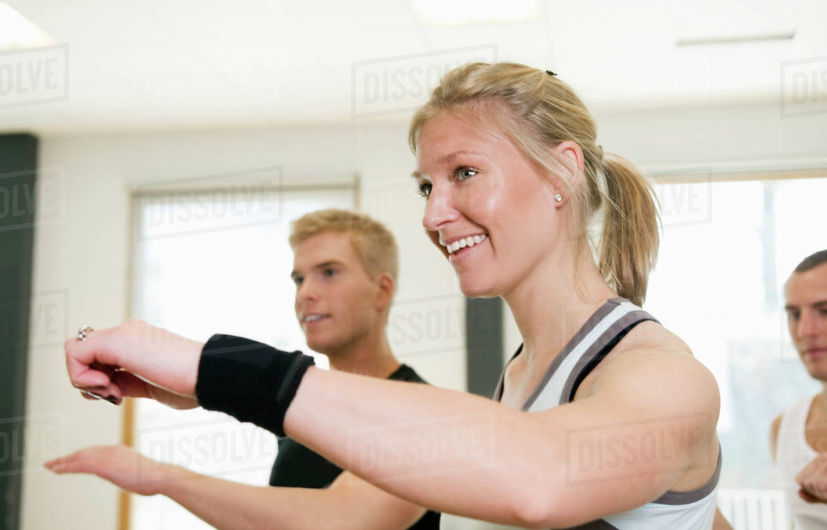 Three doing arm movements - Royalty-free Stock Photo | Dissolve