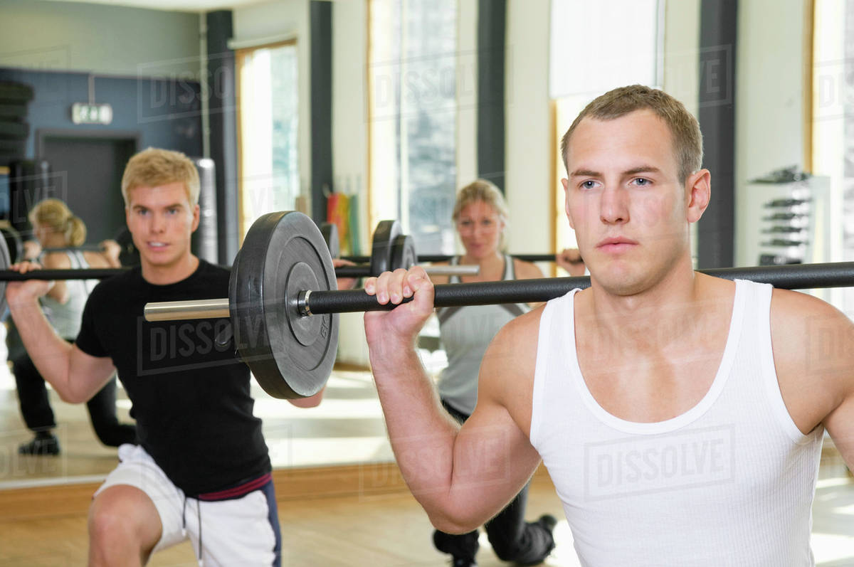 Three friends lifting weights - Stock Photo - Dissolve