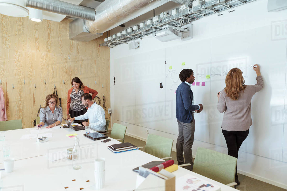 Business professionals working in board room at office - Stock Photo ...