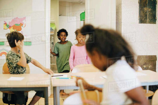 Excited students entering in classroom at elementary school - Royalty ...