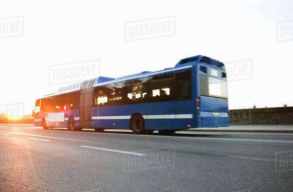 Bus driving in sunset - Stock Photo - Dissolve