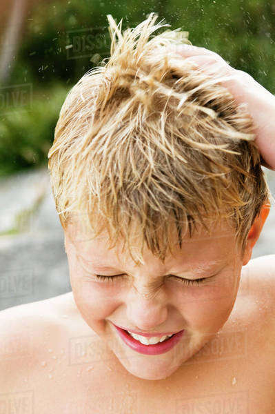 Boy scratching his head - Stock Photo - Dissolve