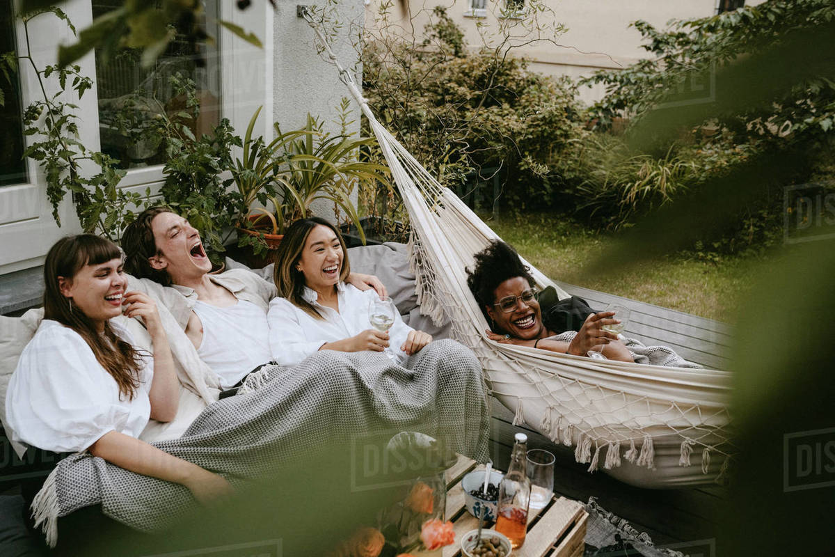High angle view of cheerful friends enjoying during social gathering ...