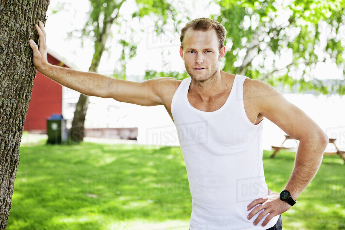 Man leaning against tree - Royalty-free Stock Photo | Dissolve