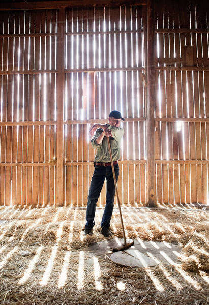 Farmer sweeping barn 2 - Stock Photo - Dissolve