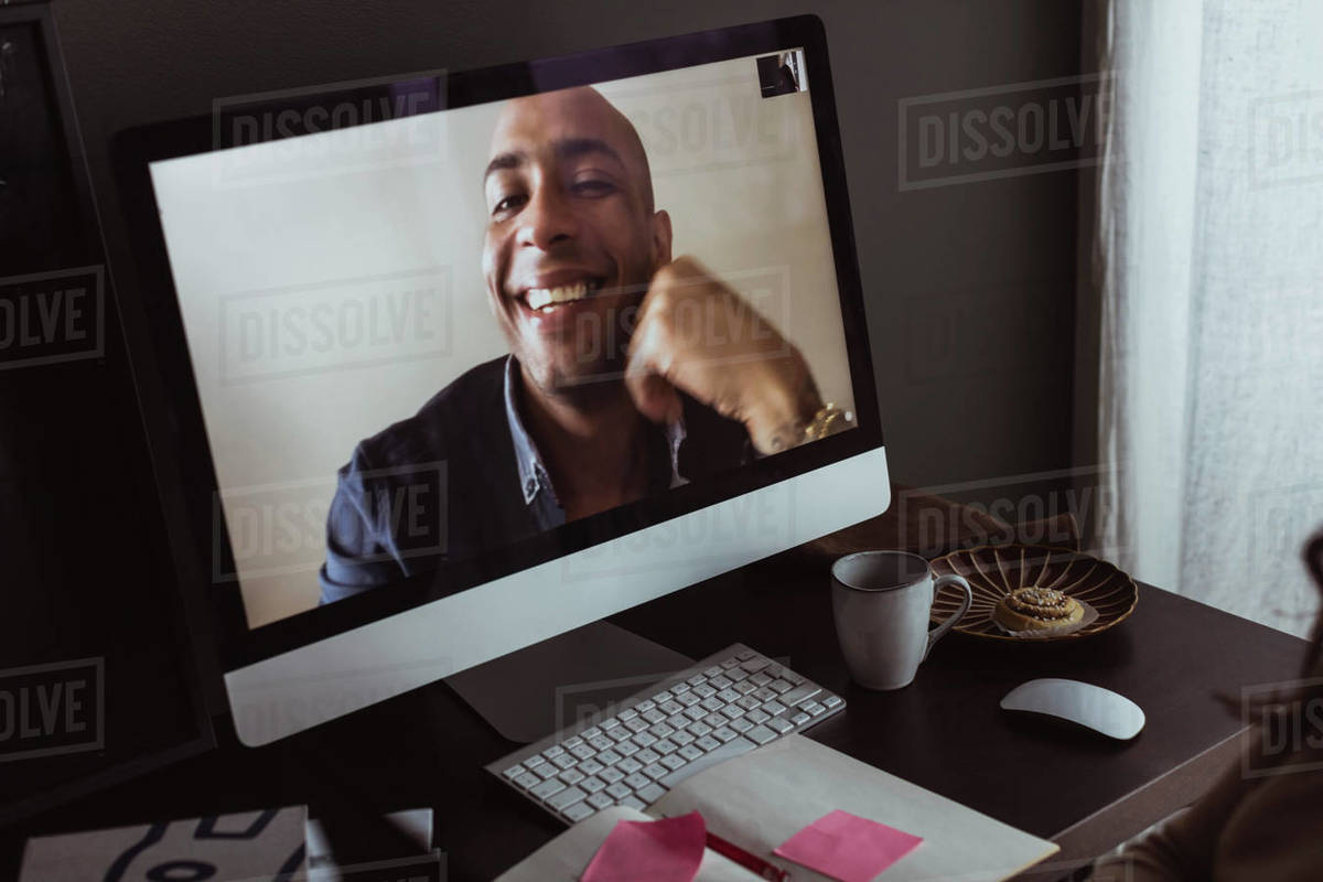 Smiling businessman on computer screen during video call - Royalty-free ...