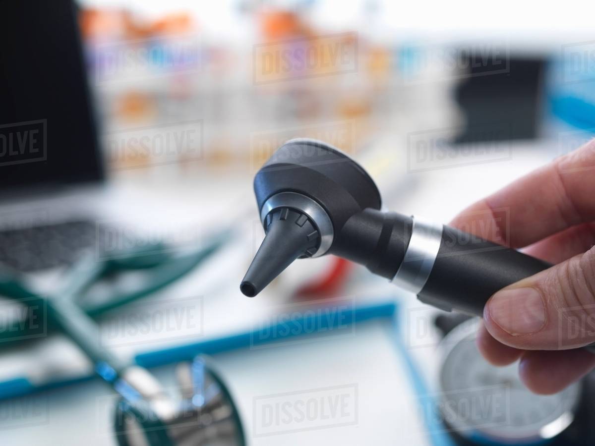 Doctor holding otoscope - Royalty-free Stock Photo | Dissolve