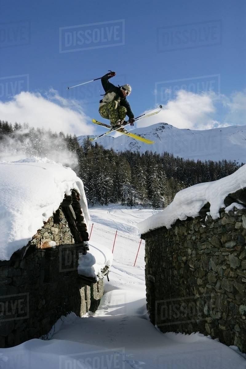 Skier jumping over buildings - Royalty-free Stock Photo | Dissolve
