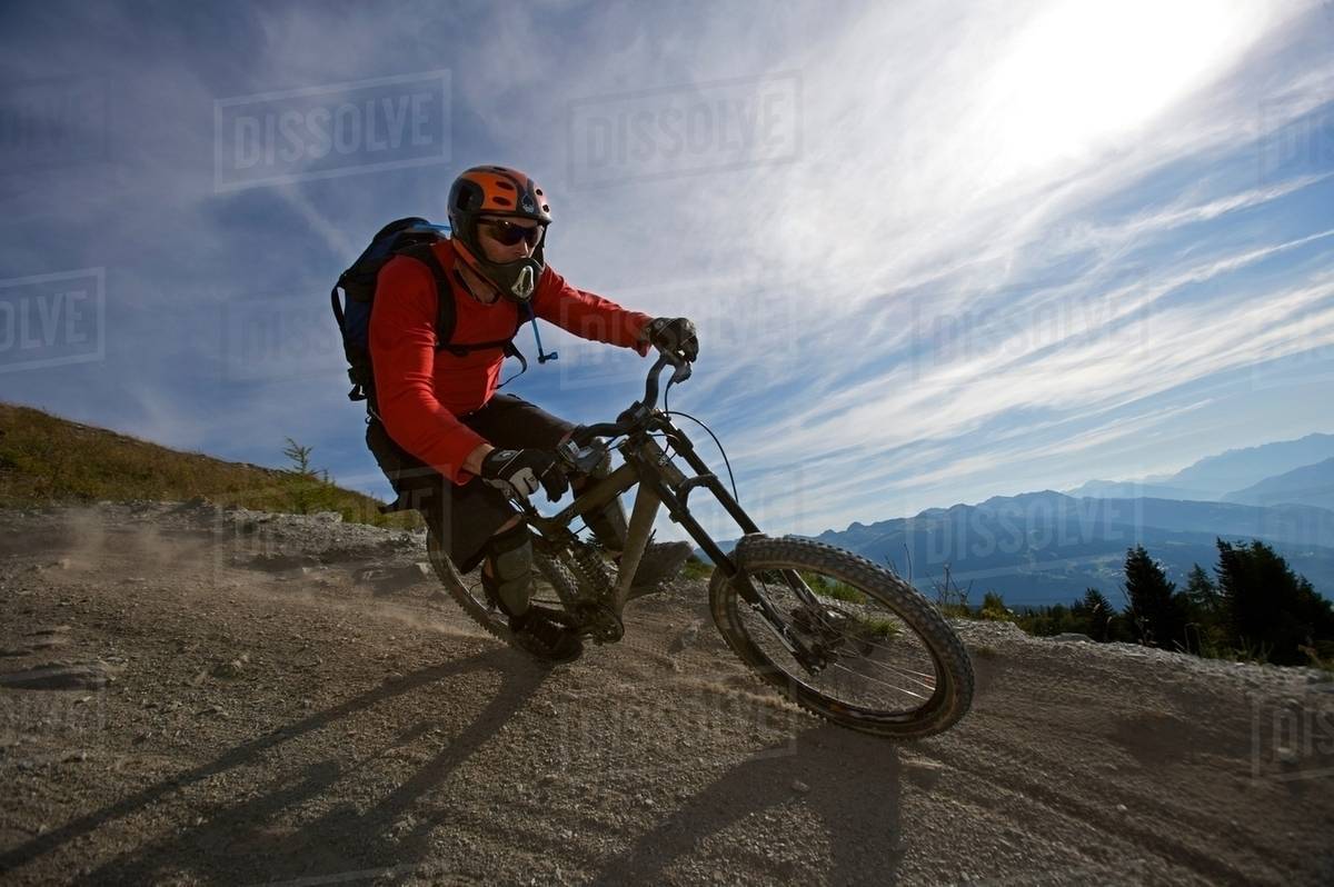 Mountain biker riding fast - Royalty-free Stock Photo | Dissolve