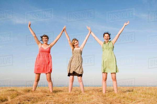 Three teenage girls hold hands up high - Royalty-free Stock Photo ...